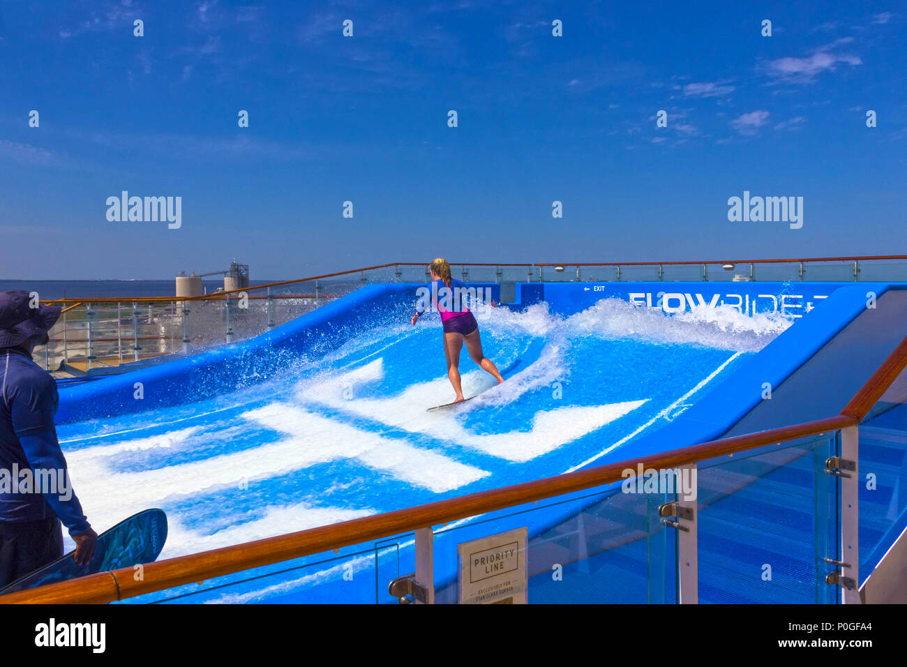 Cape Canaveral, USA - APRIL 29, 2018: Woman surfing on the FlowRider ...