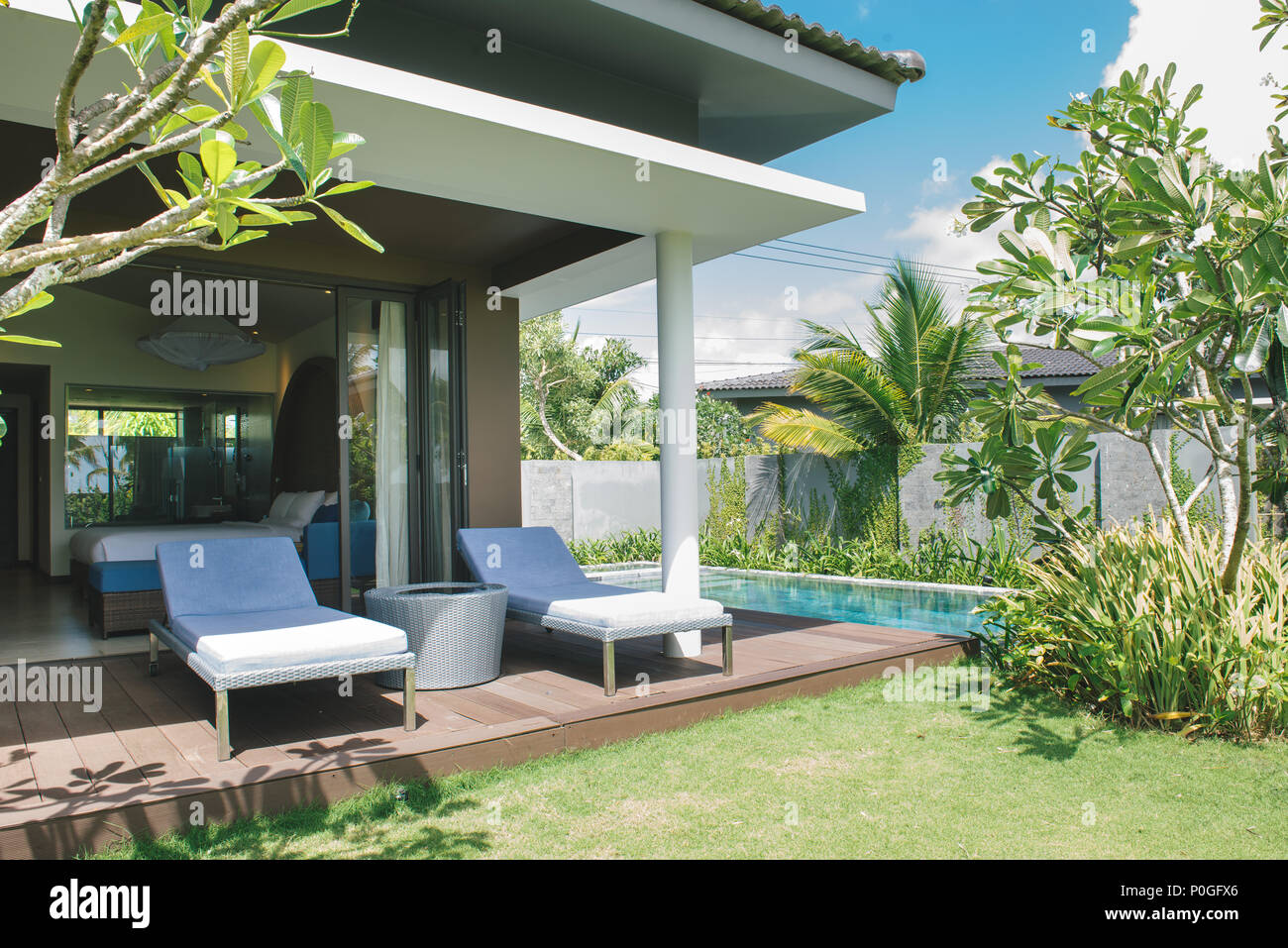 Tropical beach resort. Swimming pool near living room Stock Photo - Alamy