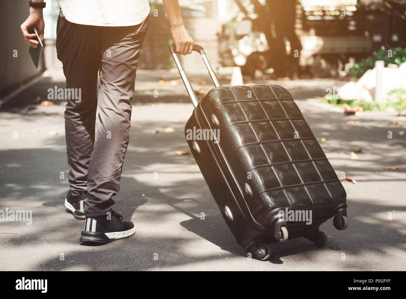 Happy man walking luggage hi-res stock photography and images - Alamy
