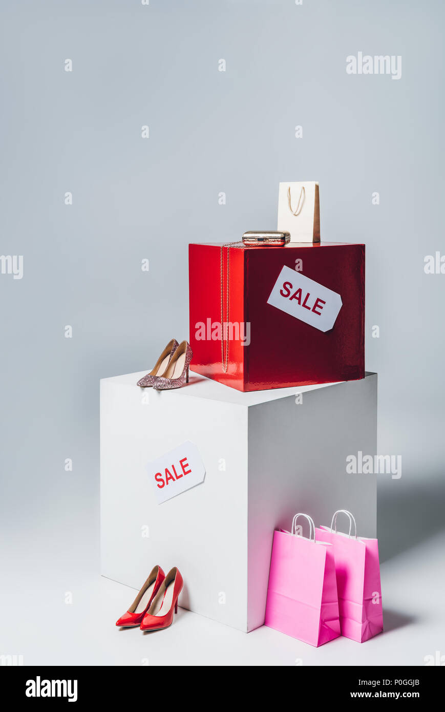 high heels, pink shopping bags and sale signs, summer sale concept ...