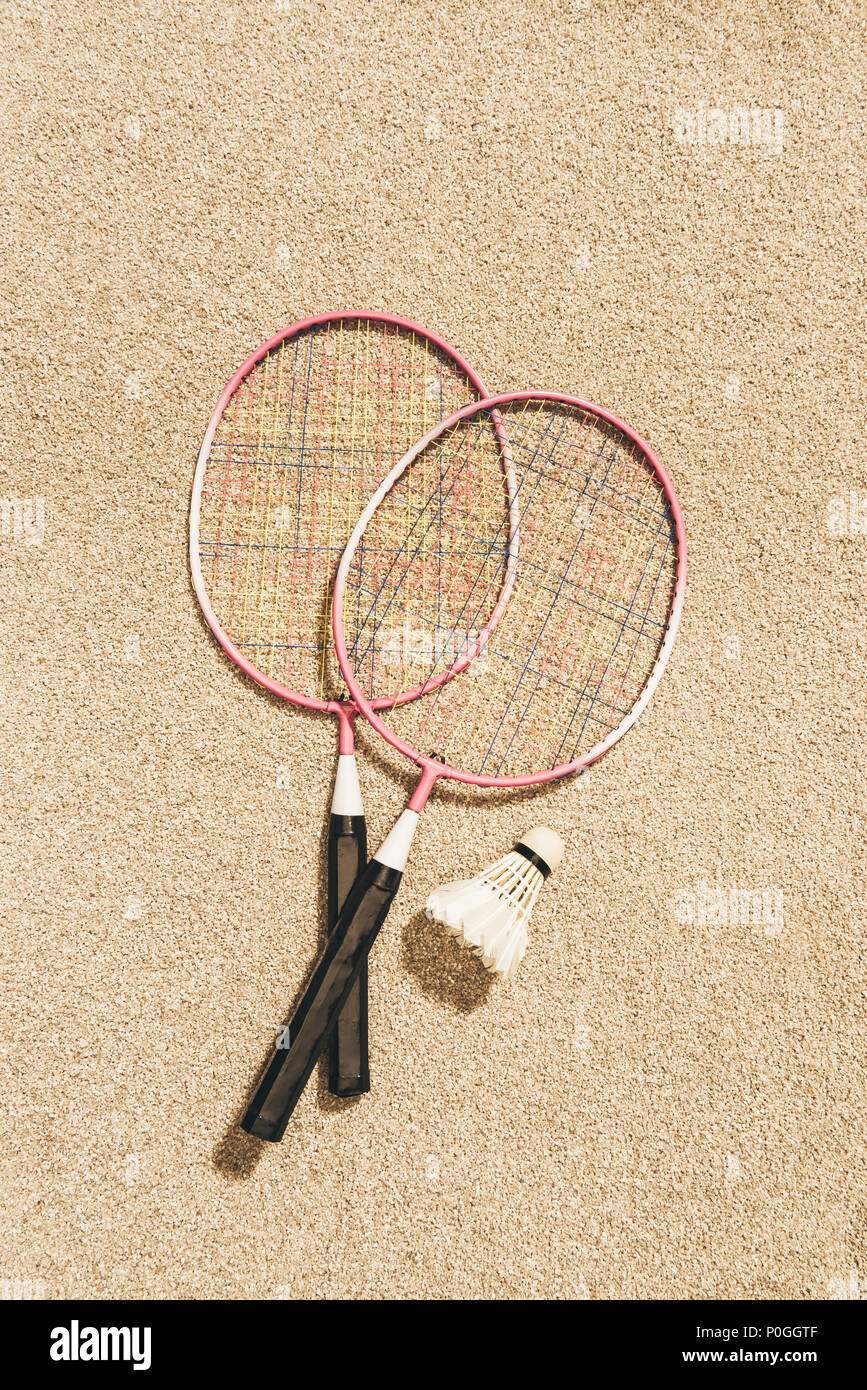 top view of arranged badminton rackets and shuttlecock on sand Stock ...