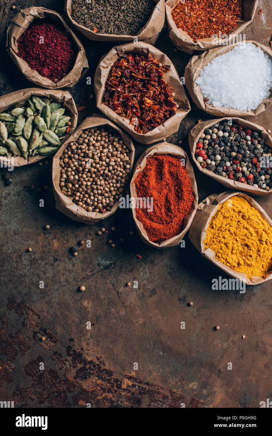 top view of colorful spices in paper bags on table Stock Photo - Alamy