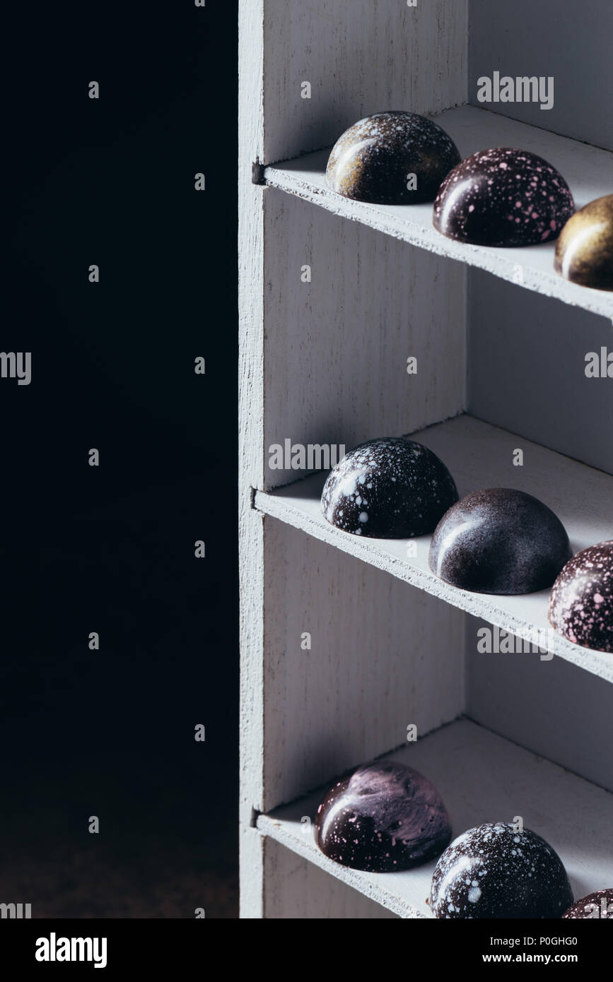 different chocolate candies placed in rows on shelves Stock Photo - Alamy
