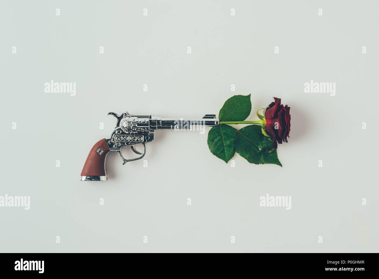 top view of red rose in gun barrel isolated on white Stock Photo - Alamy