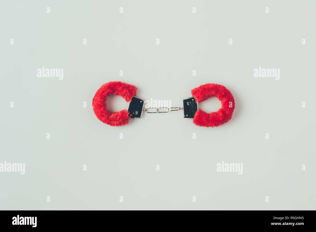 top view of locked red fluffy handcuffs isolated on white Stock Photo ...