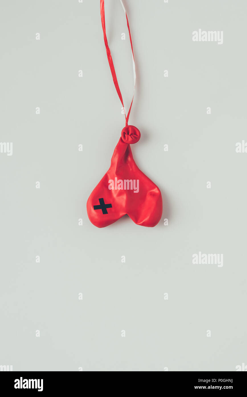 top view of flipped over deflated balloon on ribbon isolated on white ...