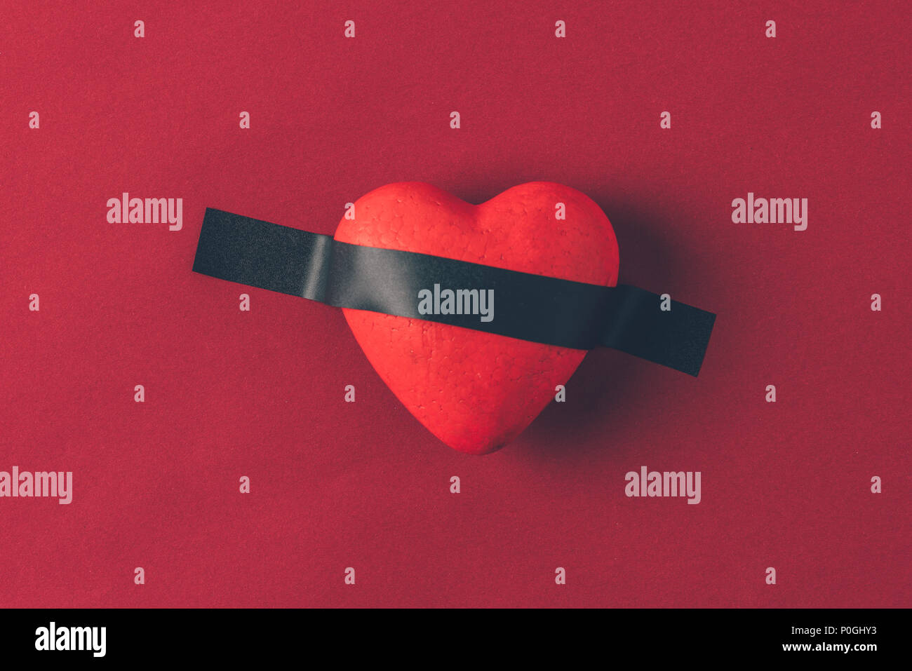 top view of red heart under insulating tape on red Stock Photo - Alamy