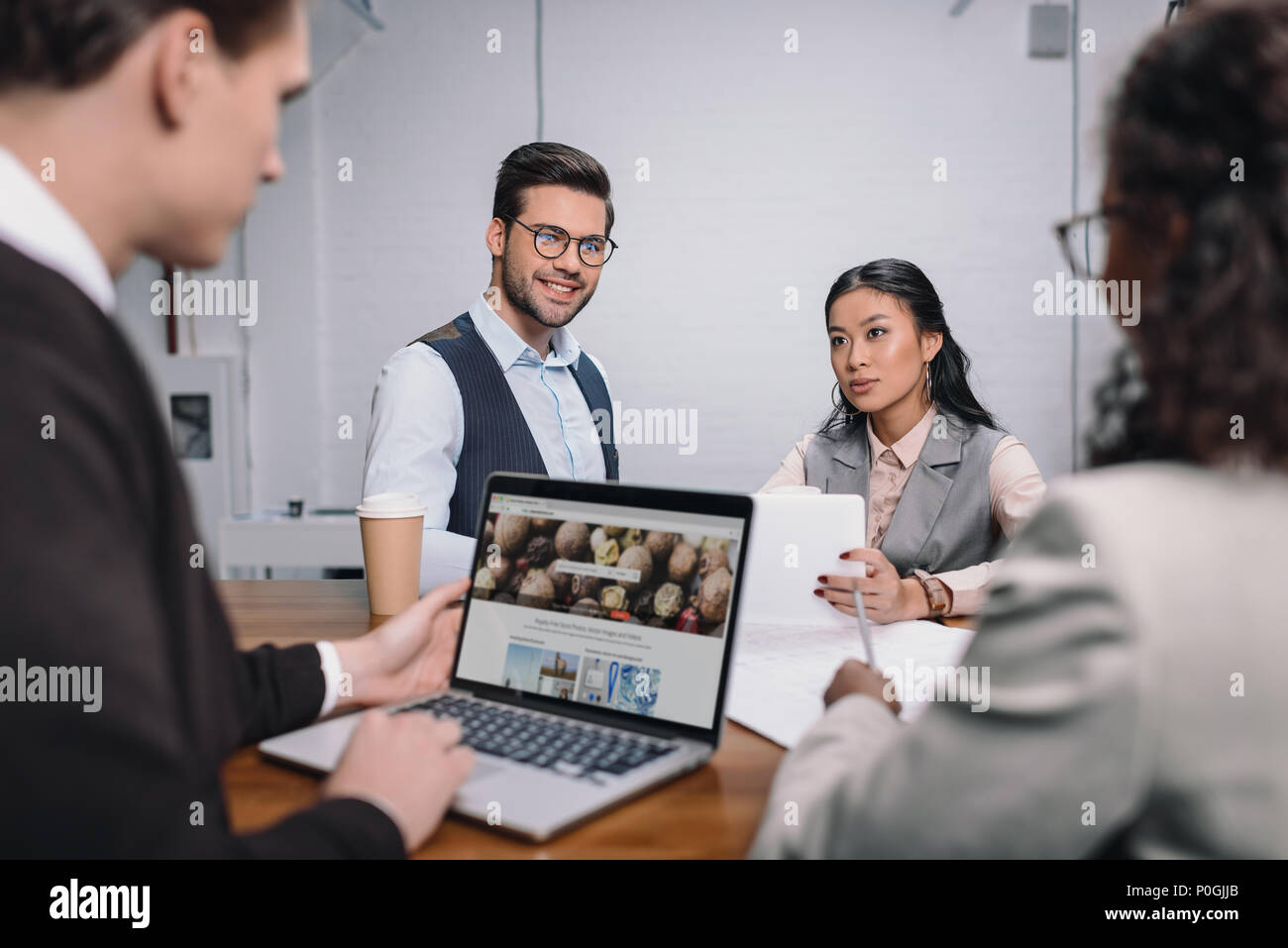 multiethnic business team with documents and laptop with depositphotos ...