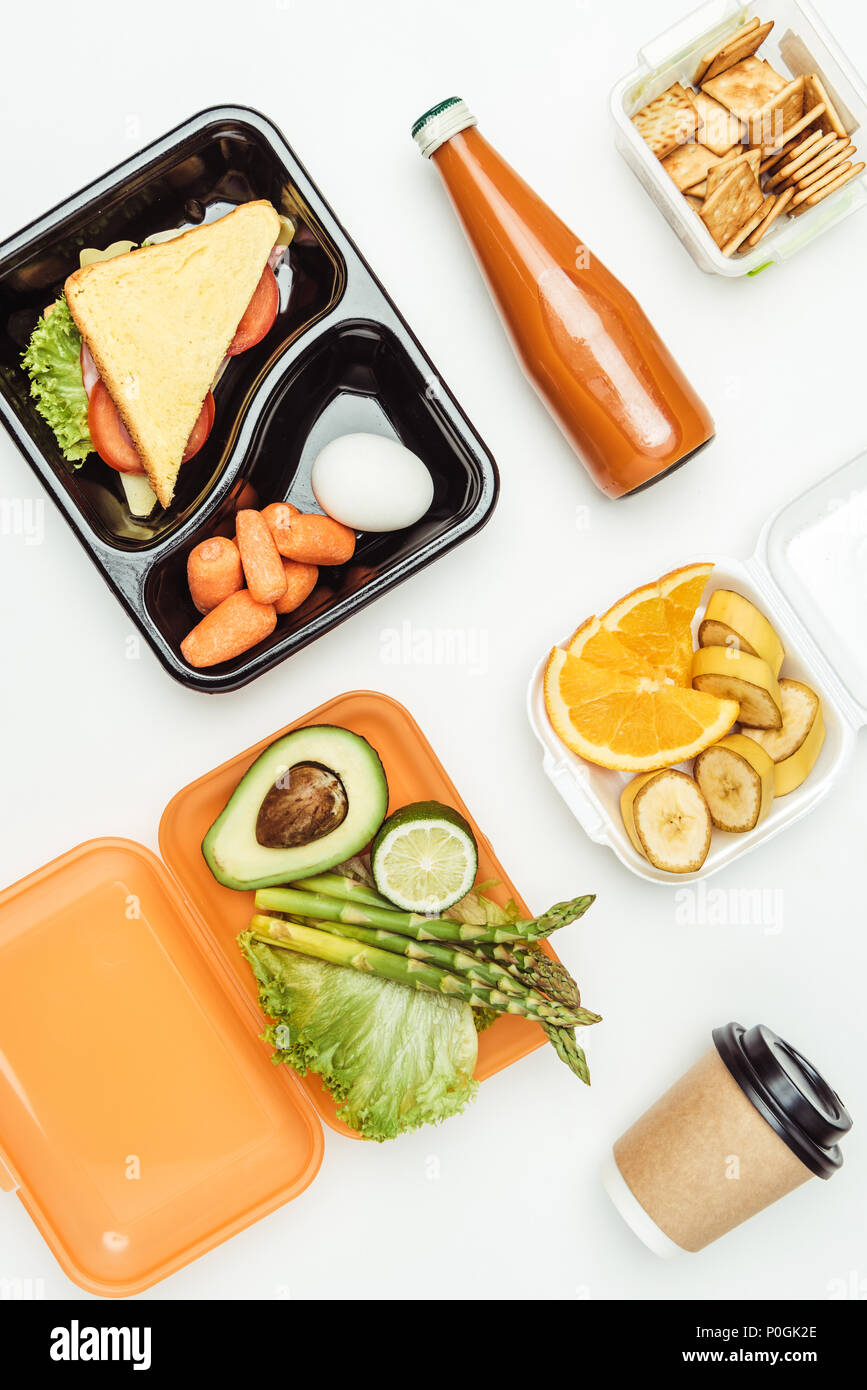 flat lay of yummy lunch and fruits in lunch boxes isolated on white ...