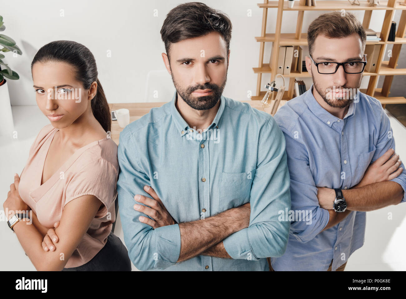 high angle view of serious business people with crossed arms standing ...