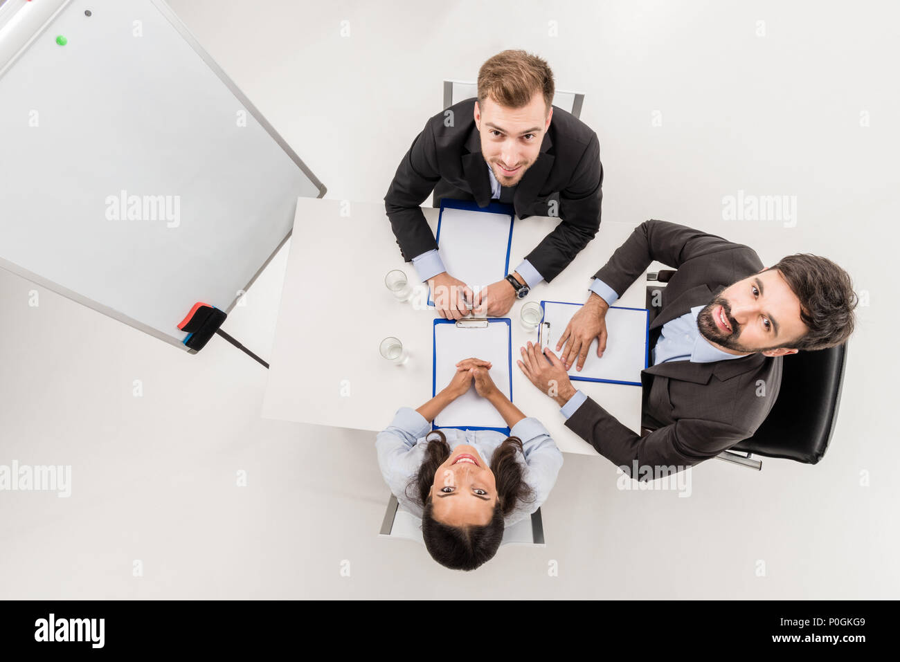 overhead view of young business people looking up during business ...