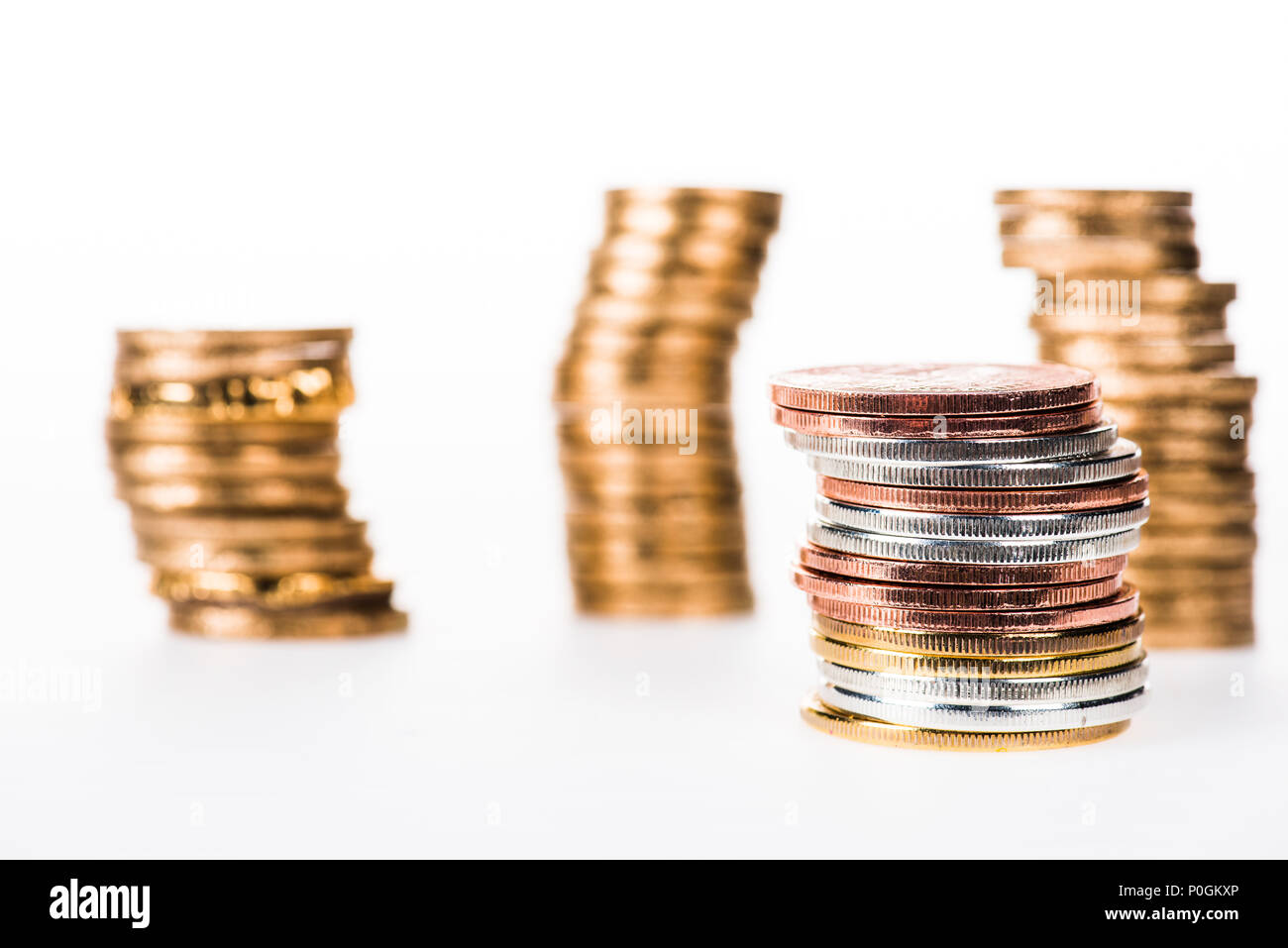 selective focus of various stacked shiny coins isolated on white Stock ...