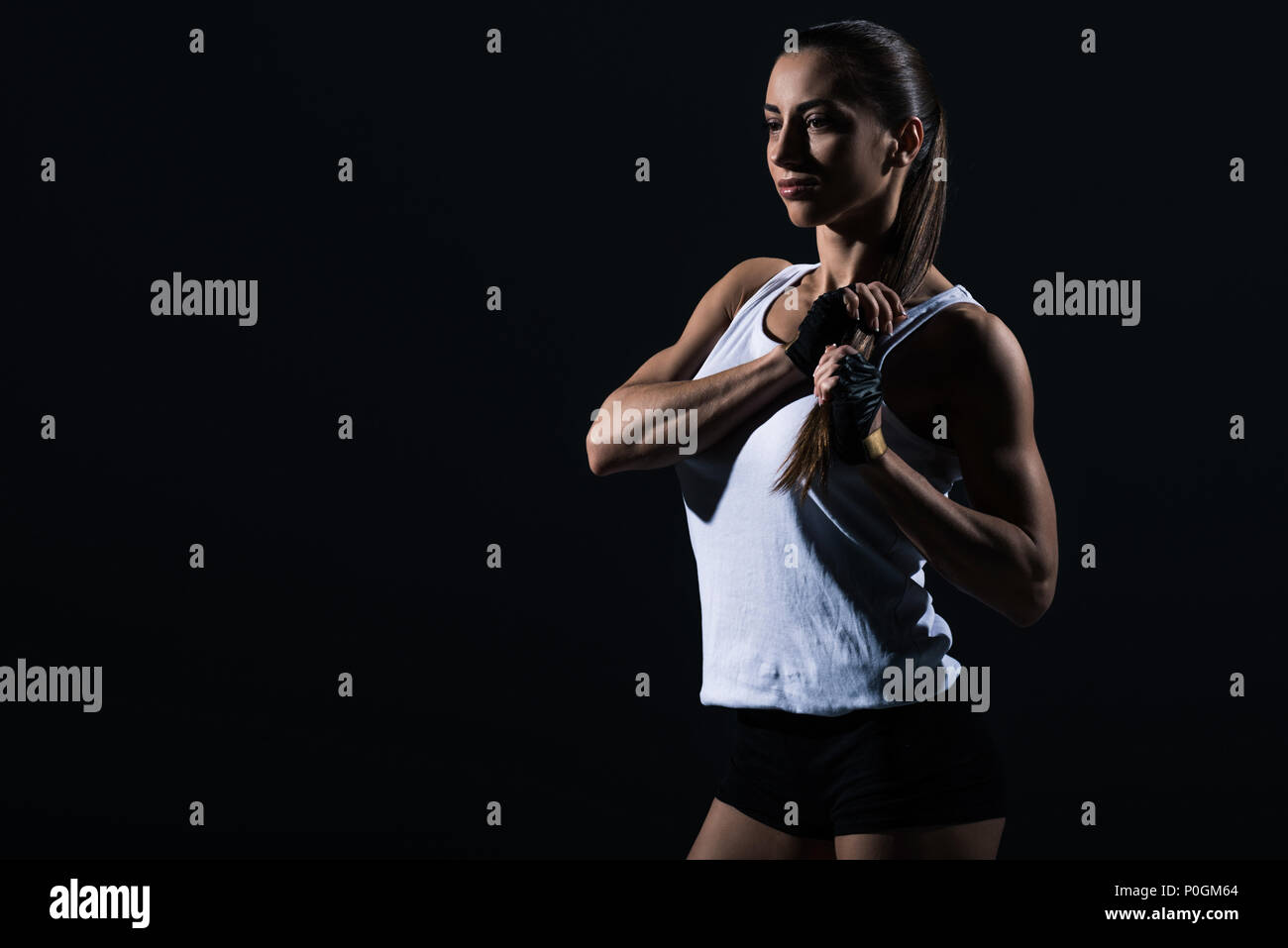 beautiful female bodybuilder posing in sportswear, isolated on black ...