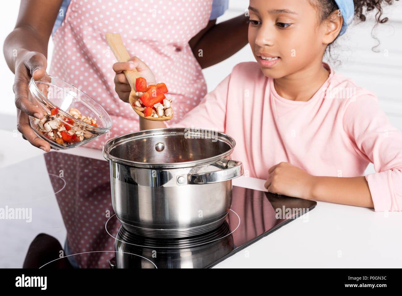 african american mother and daughter cooking on kitchen Stock Photo - Alamy