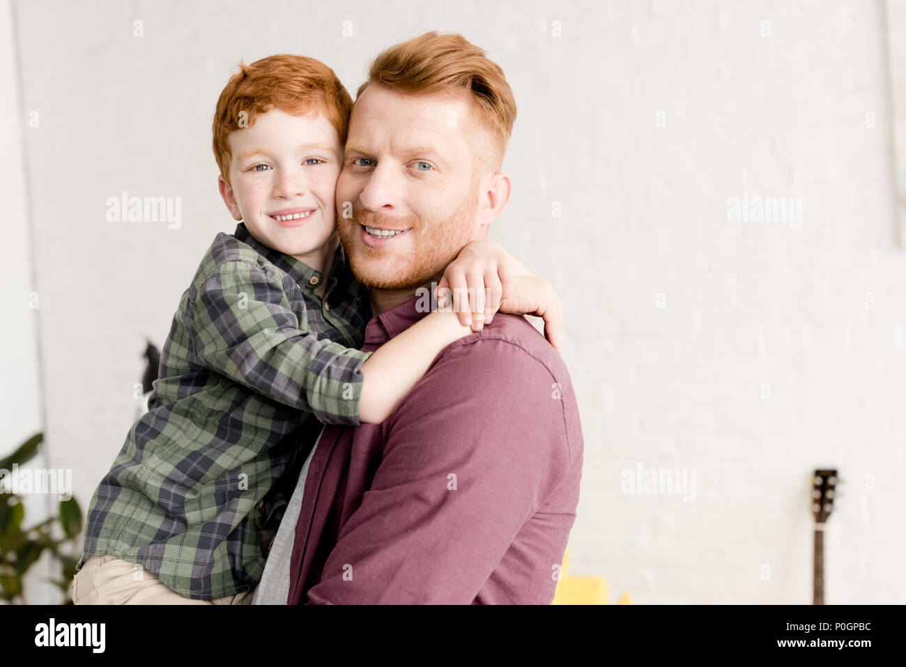 happy redhead father and son hugging and smiling at camera Stock Photo ...