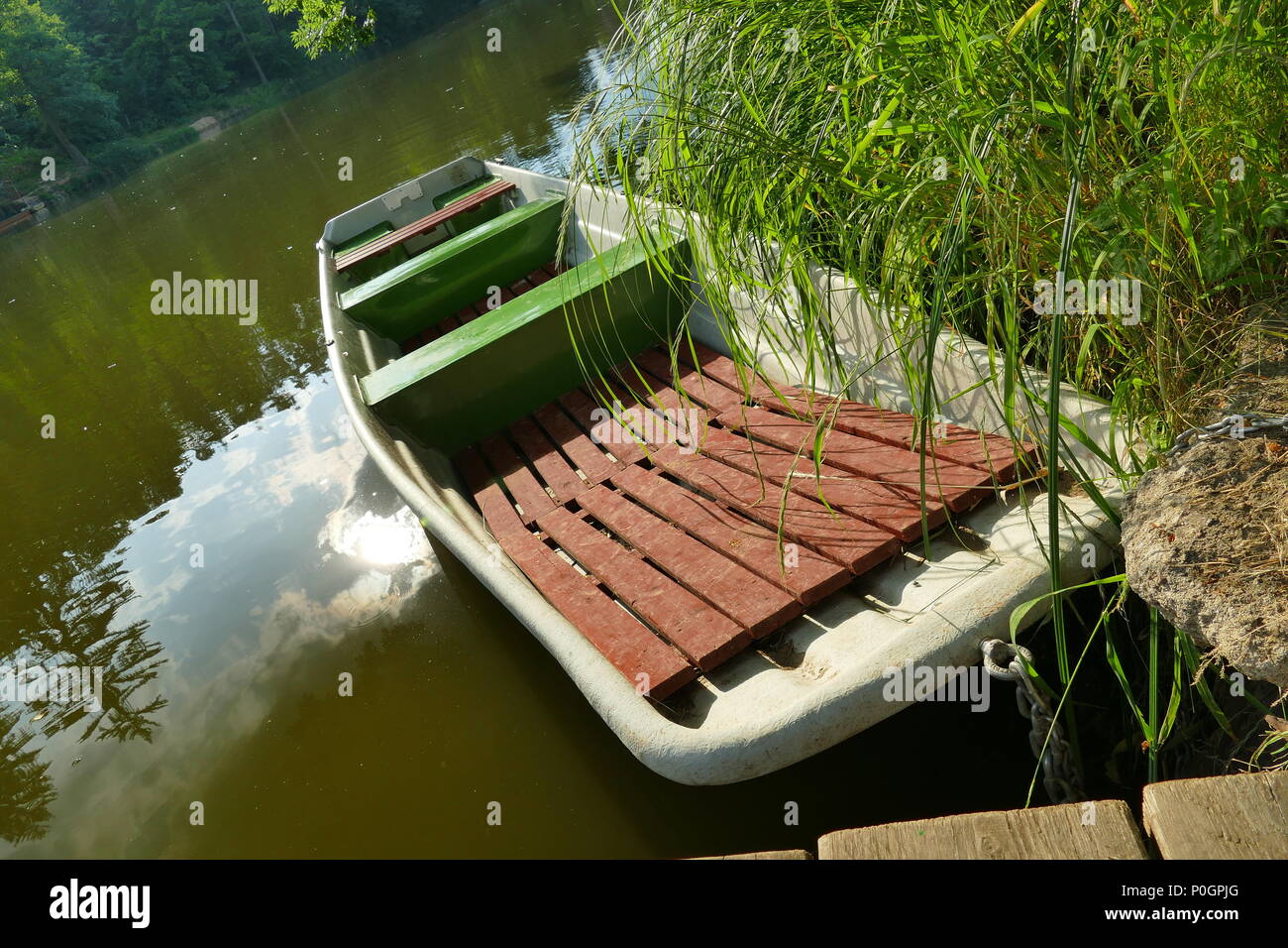 An old punt boat on a pond Stock Photo - Alamy
