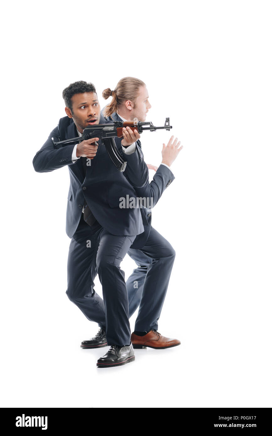 african american bodyguard with rifle and frightened client, isolated ...