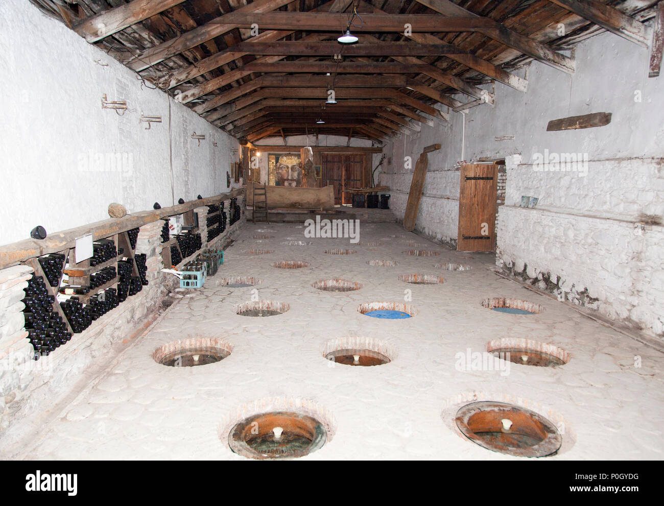 Wine containers built under the floor inside traditional winery in ...