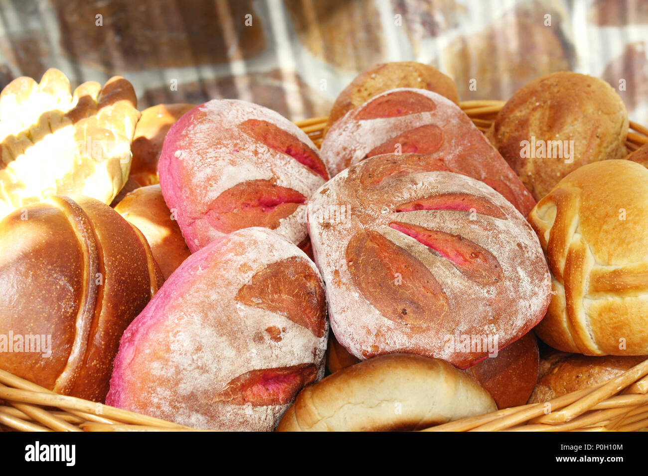 Detail of a wicker basket containing different types of bread loaves ...