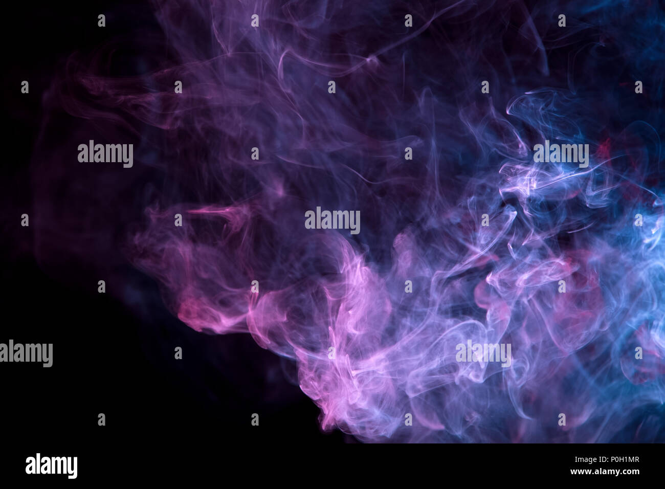 Cloud of pink and purple smoke on a black isolated background ...