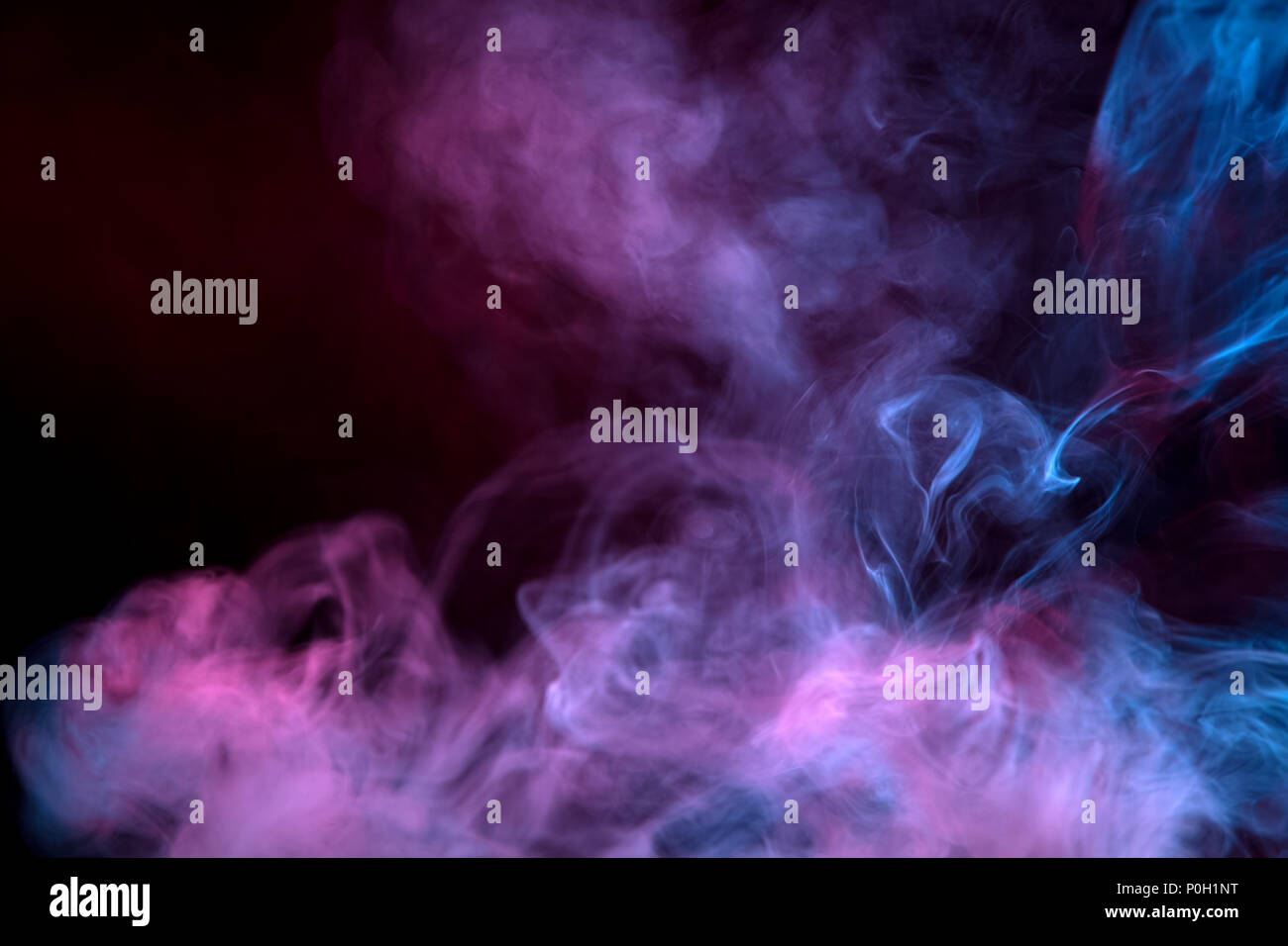 Cloud of pink and purple smoke on a black isolated background ...