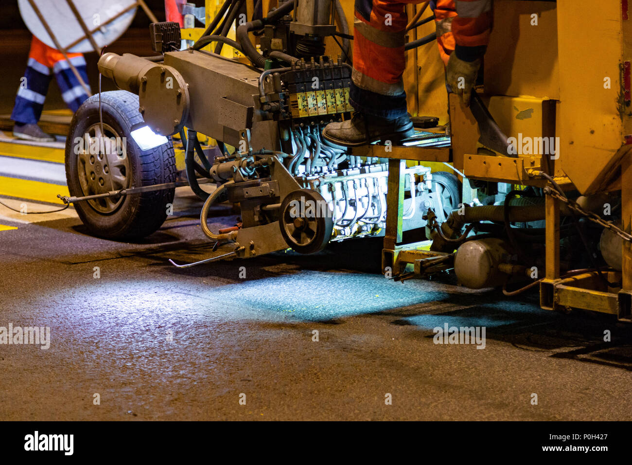The working machine performs repair work on the road in the night Stock ...