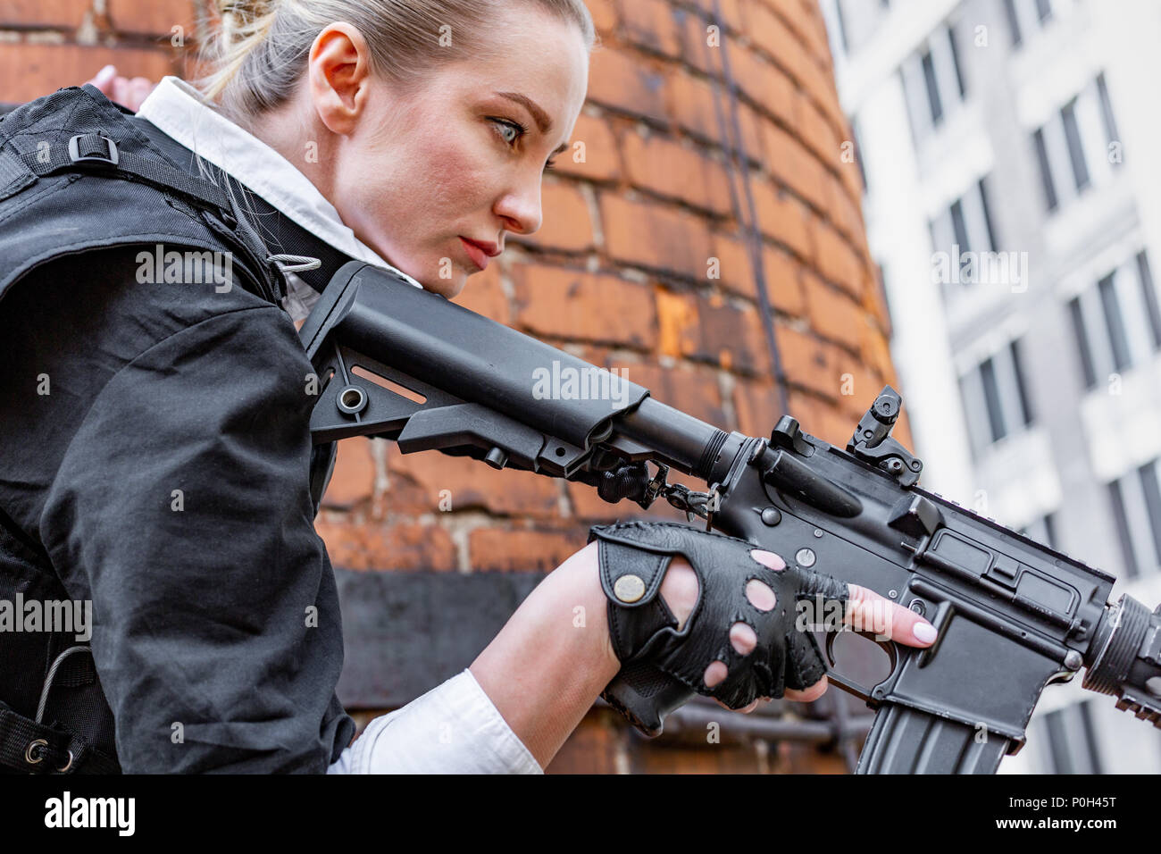 Powerful Woman Holding Gun. War Action Movie Style Stock Photo - Alamy