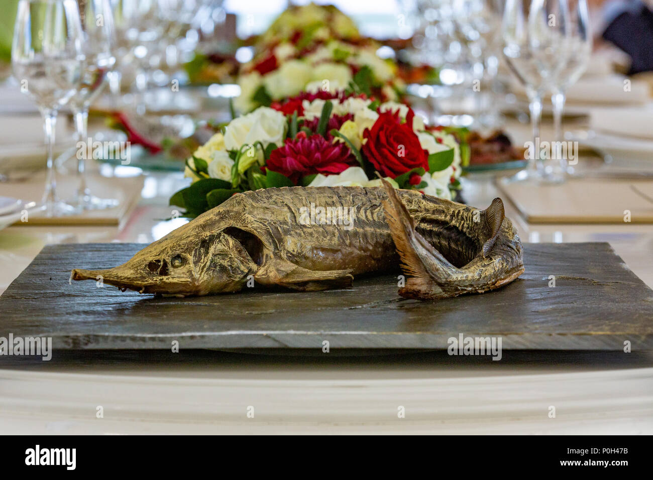 Baked sturgeon fish on a festive table. Healthy food. Russian ...