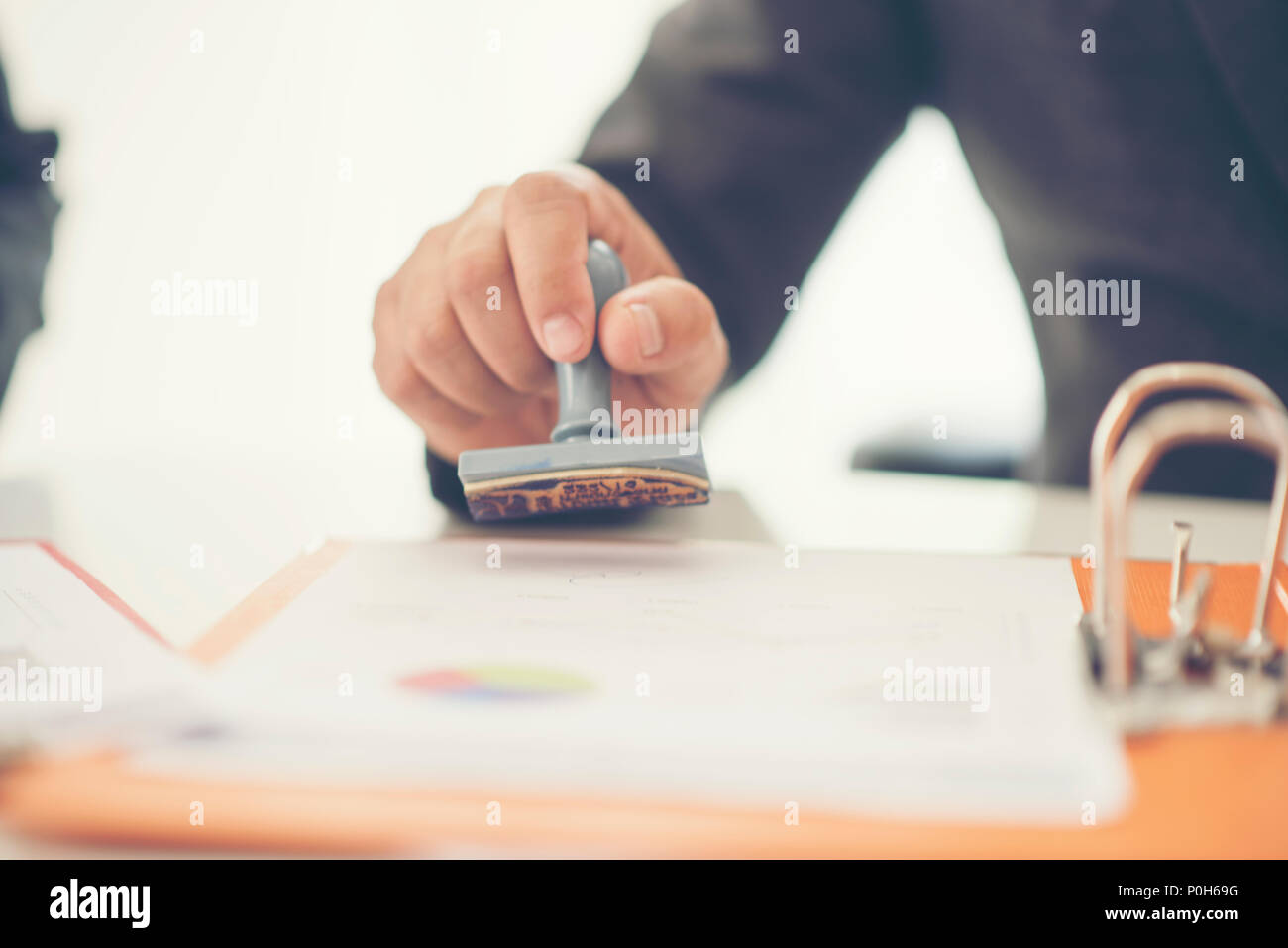 Business hand putting stamp on a document, close up Stock Photo - Alamy