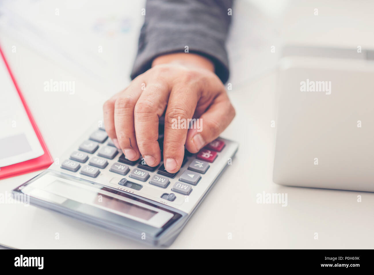 Businessman using a calculator to calculate the numbers. Accounting ...