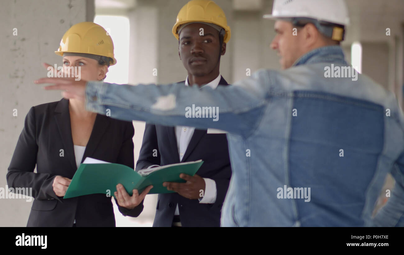 Business people group on meeting and presentation in construction site ...