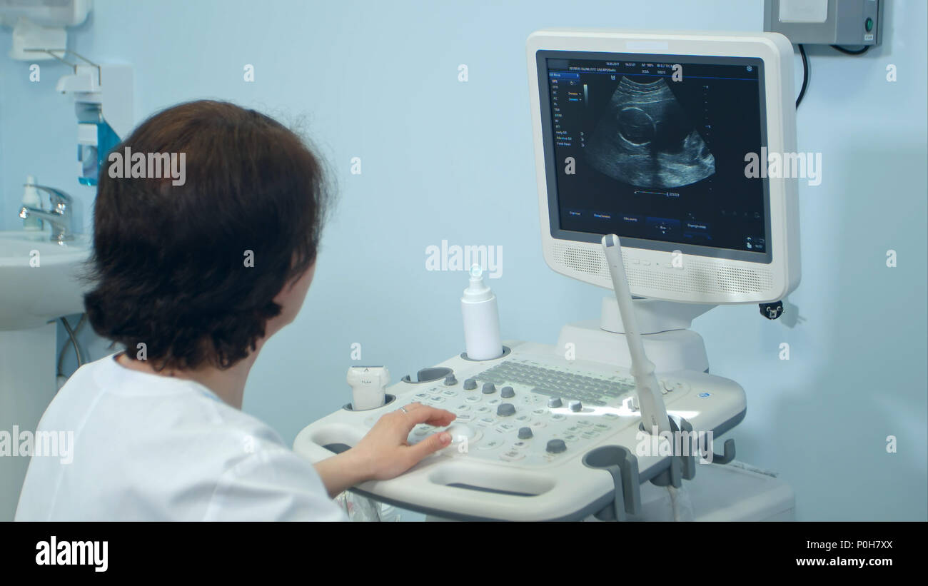 Female doctor working at modern ultrasound equipment Stock Photo - Alamy