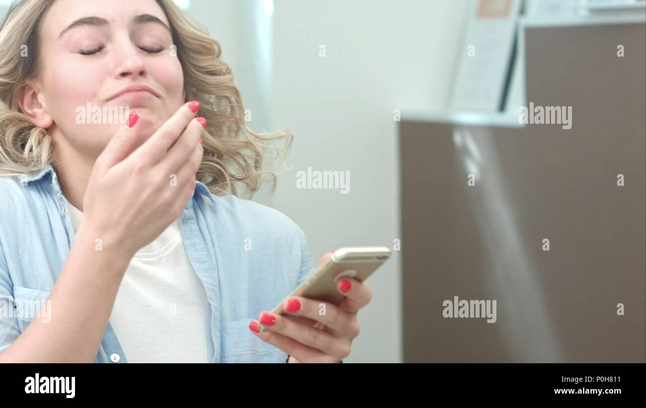 Sick young girl use mobile phone and sneeze Stock Photo - Alamy