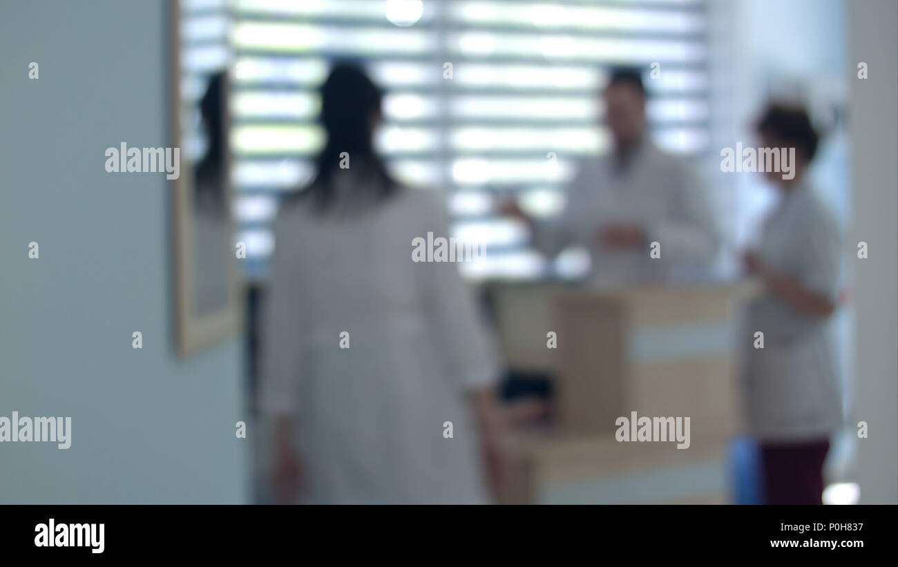 Busy hospital reception with doctors and receptionists Stock Photo - Alamy