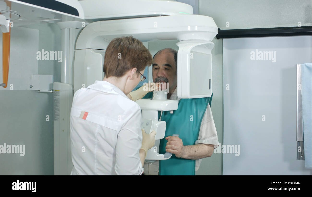 Doctor or radiologist helping senior man doing computer analyzes of ...