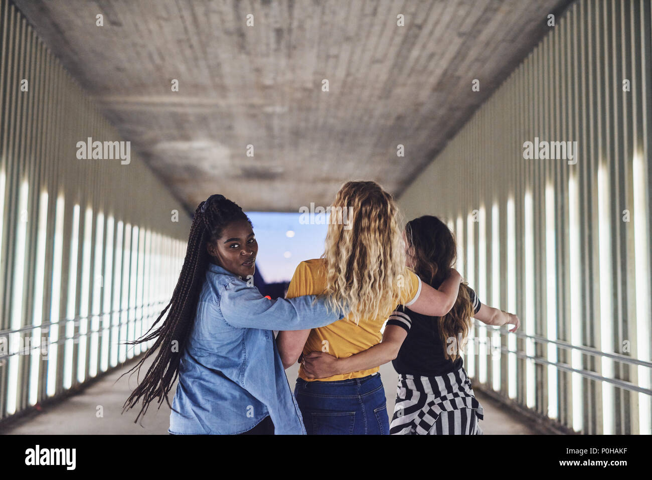 Carefree group of diverse young girlfriends having fun while walking ...