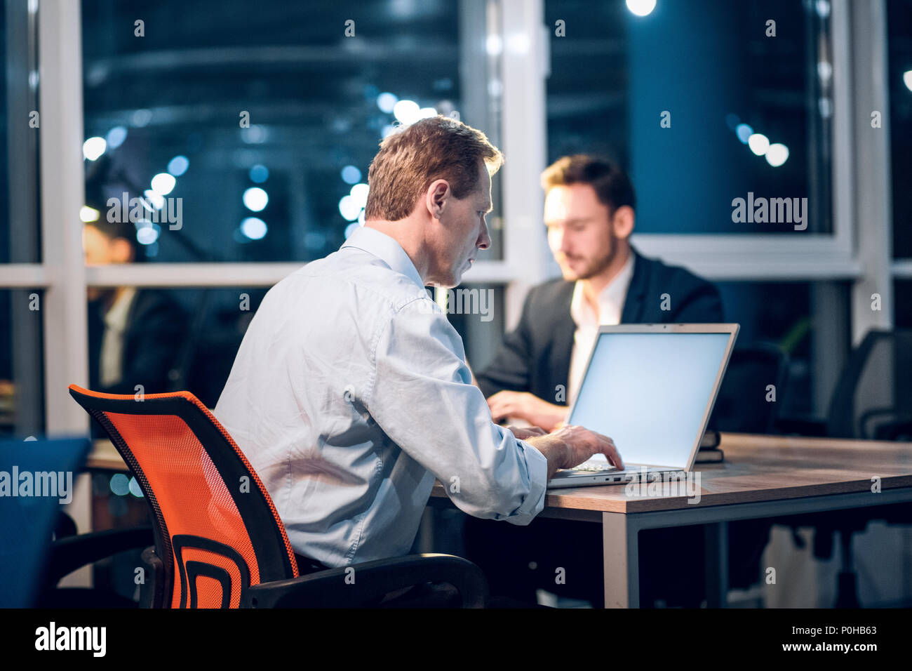Business people working late in hi-res stock photography and images - Alamy