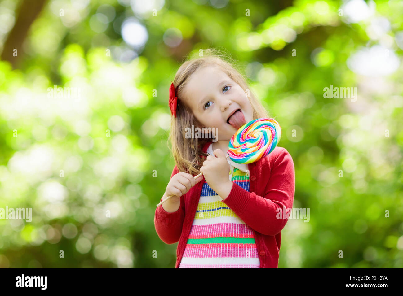 Cute Little Girl With Big Colorful Lollipop Child Eating Sweet Candy cute-little-girl-with-big-colorful-lollipop-child-eating-sweet-candy