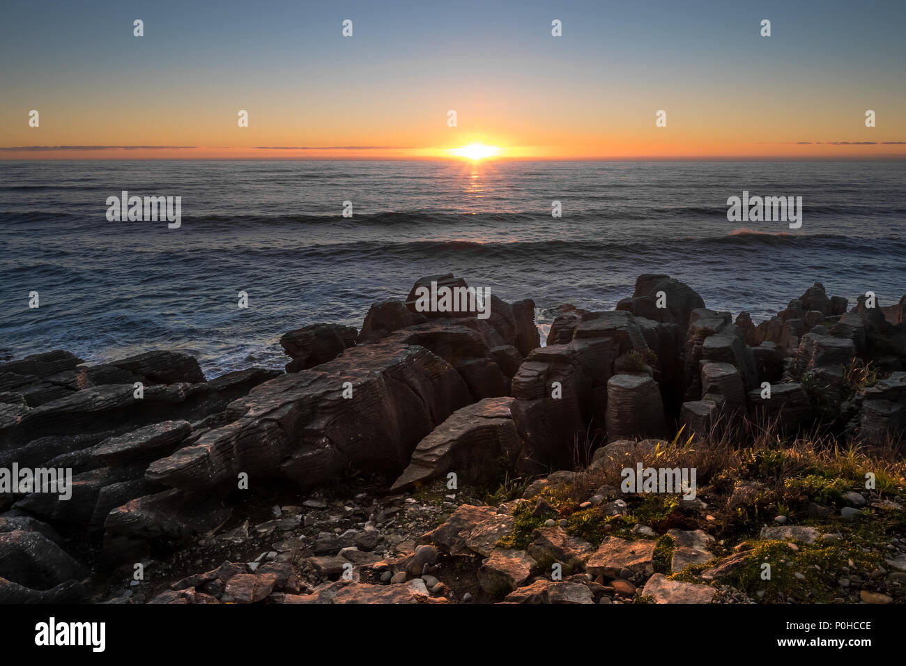 Sunset at Punakaiki pancake rocks and blowholes in the west coast of ...