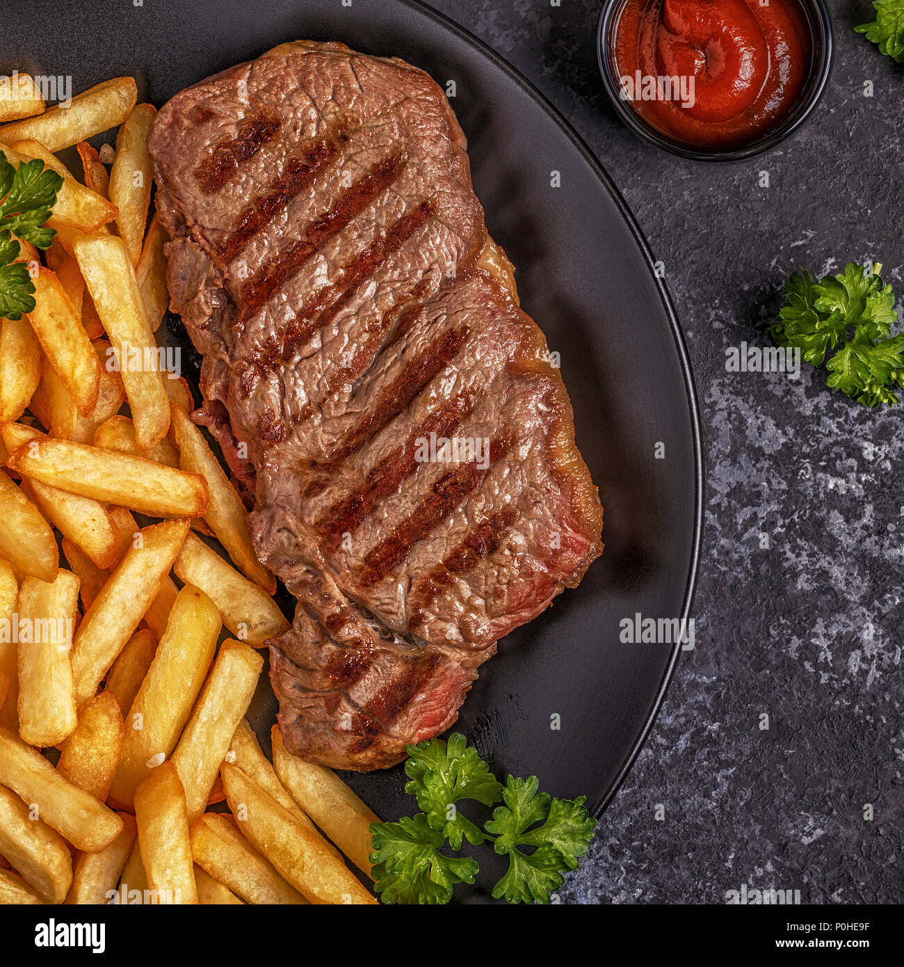 Beef barbecue steak with french fries, top view Stock Photo - Alamy