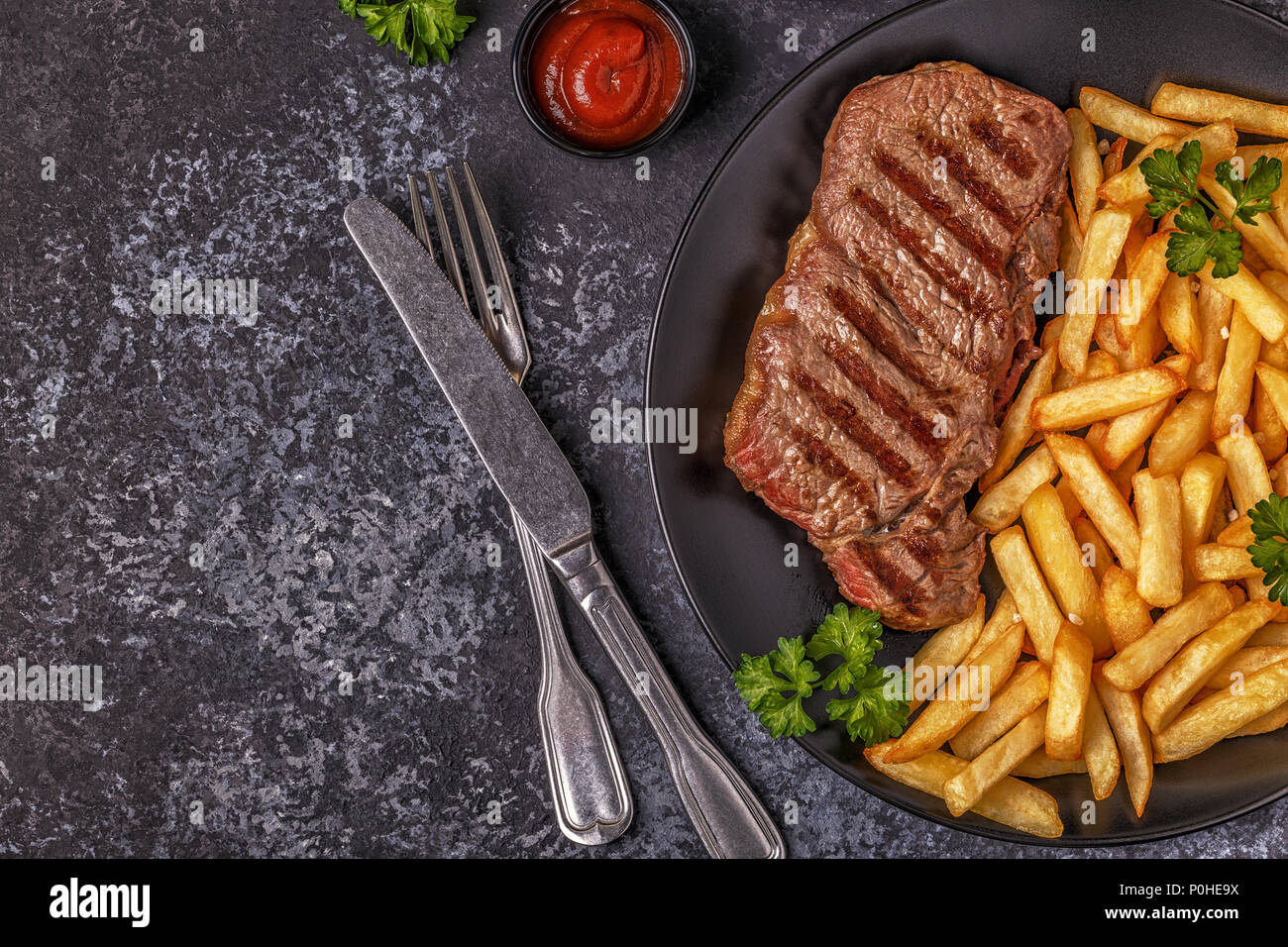 Beef barbecue steak with french fries, top view Stock Photo - Alamy