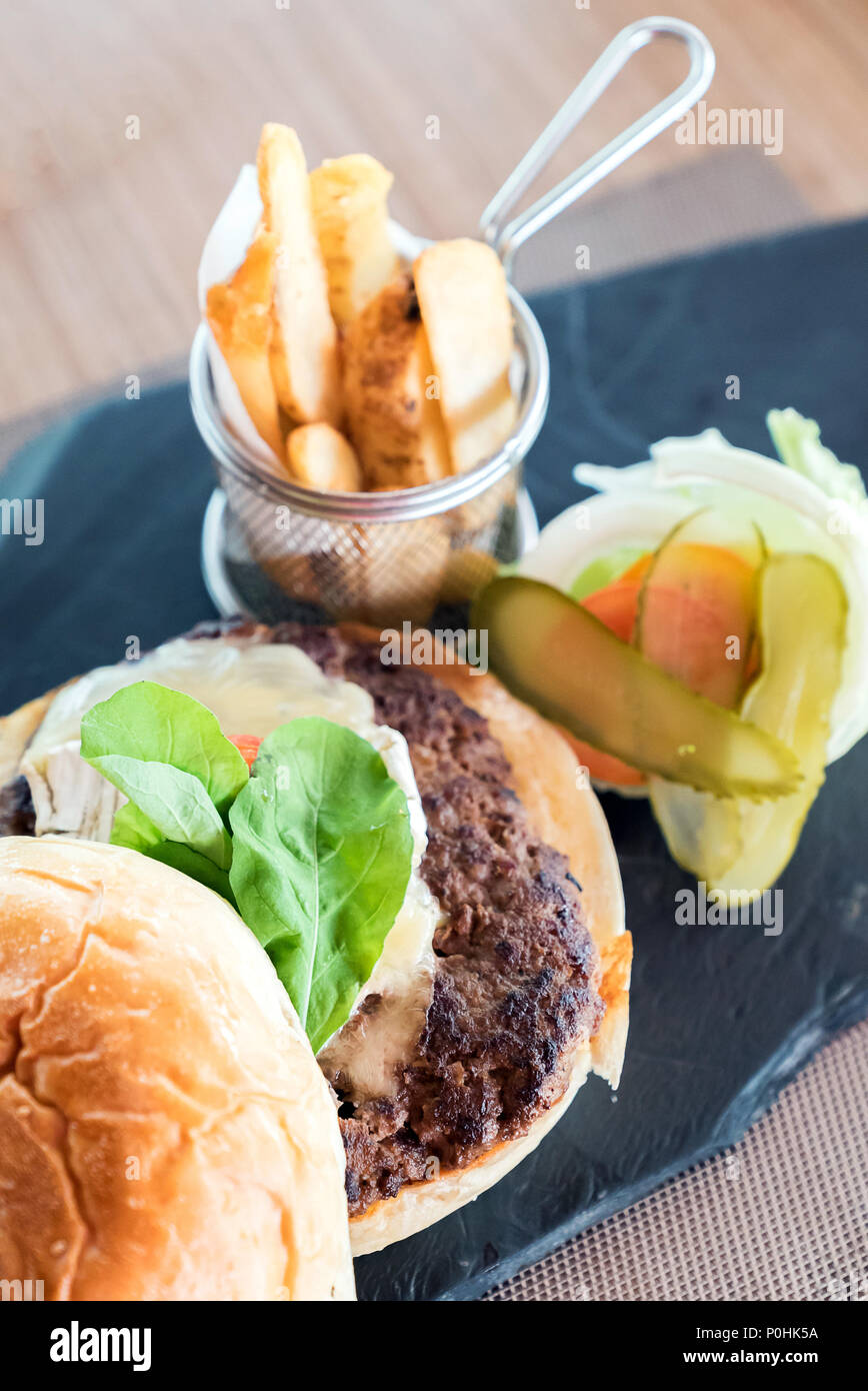 Homemade overload beef hamburger with fresh vegetables and cheese with ...