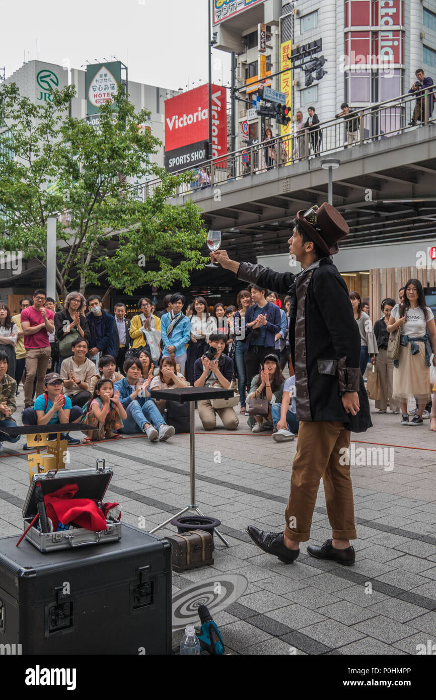 Street performer in top hat busking, a magic show, Shinjuku, near the ...