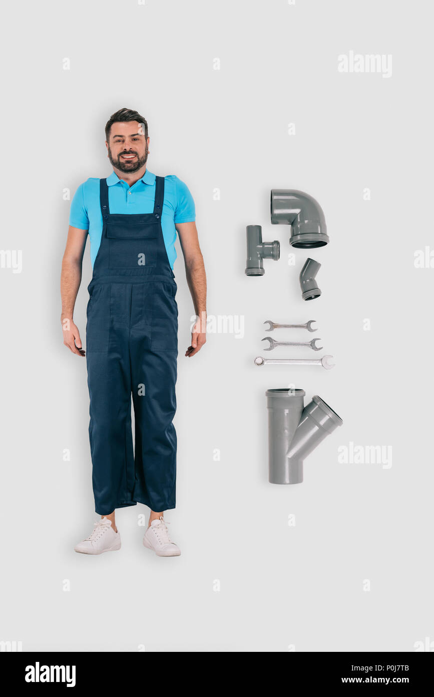 top view of plumber with pipes and spanners isolated on white ...