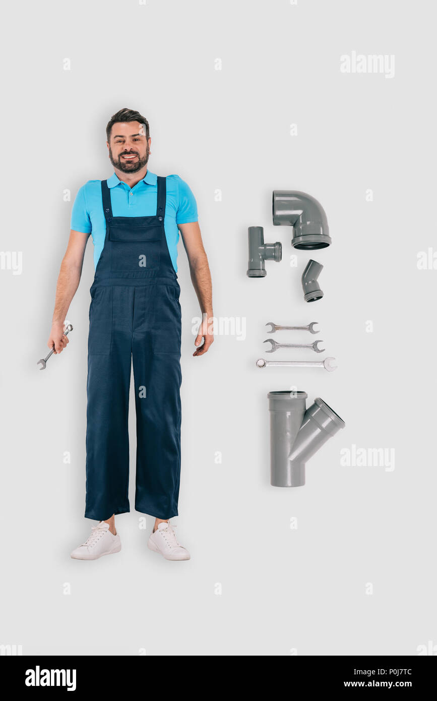 top view of plumber with spanners and pipes isolated on white ...
