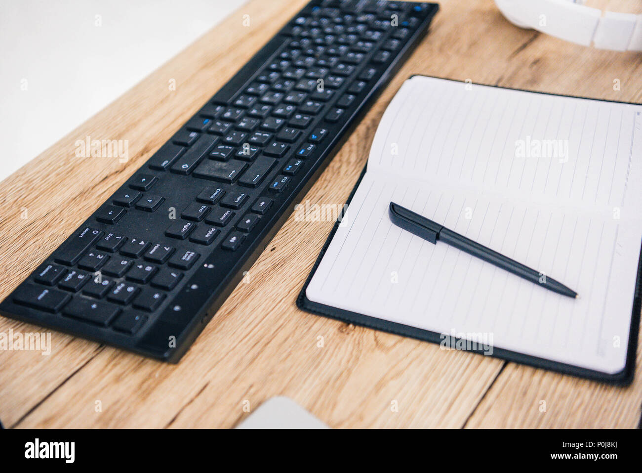 closeup shot of computer keyboard, empty textbook with pen and ...