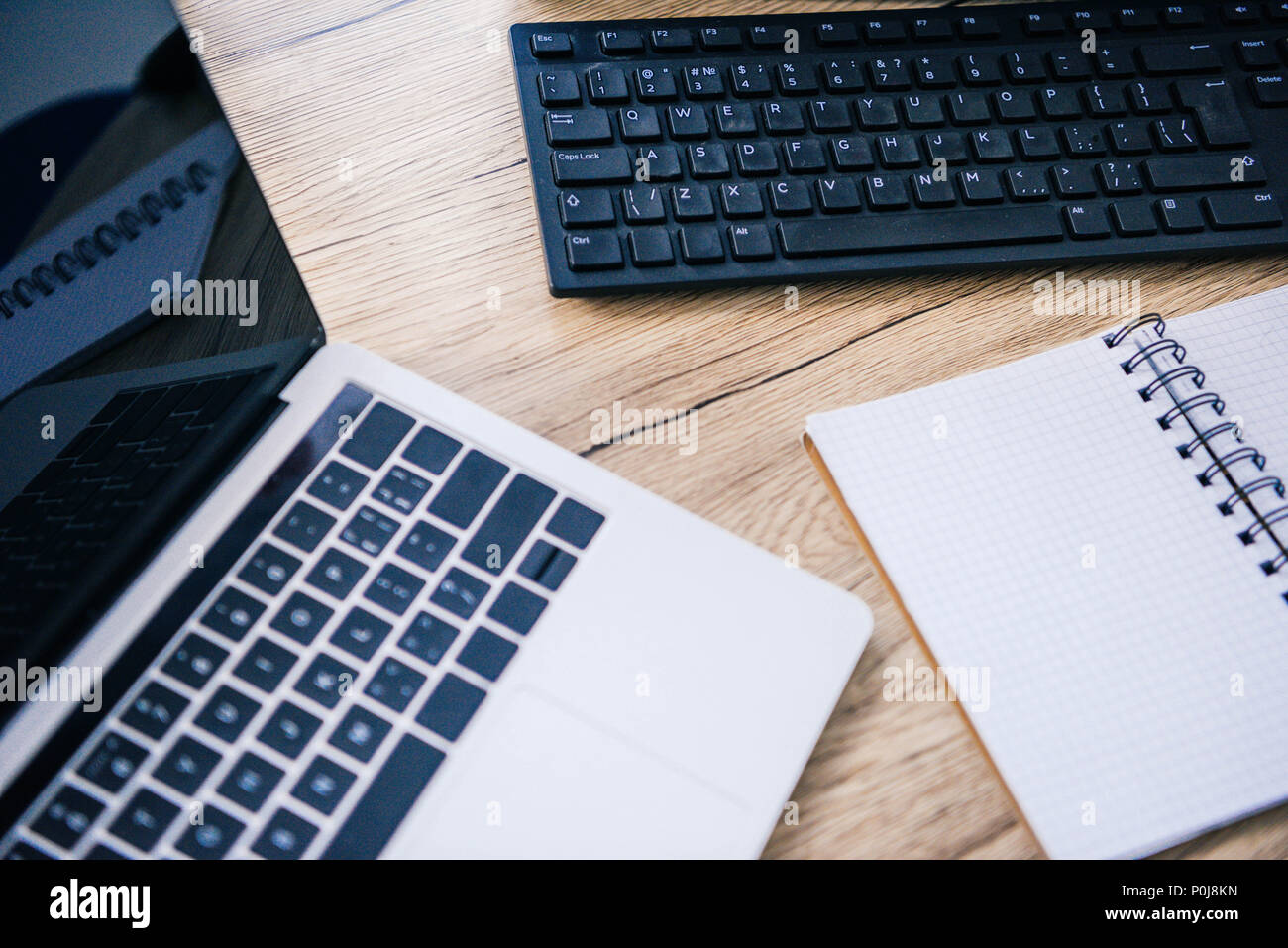 high angle view of laptop with blank screen, empty textbook and ...