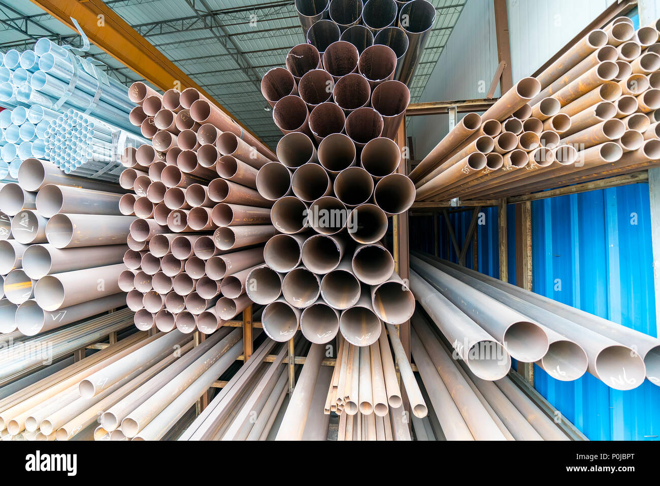 Steel Pipes Industry Construction stacked in Factory warehouse Stock ...