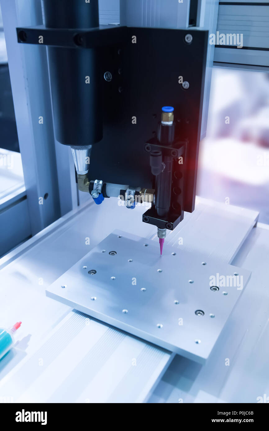 Robot holding glue syringe Injection Stock Photo - Alamy