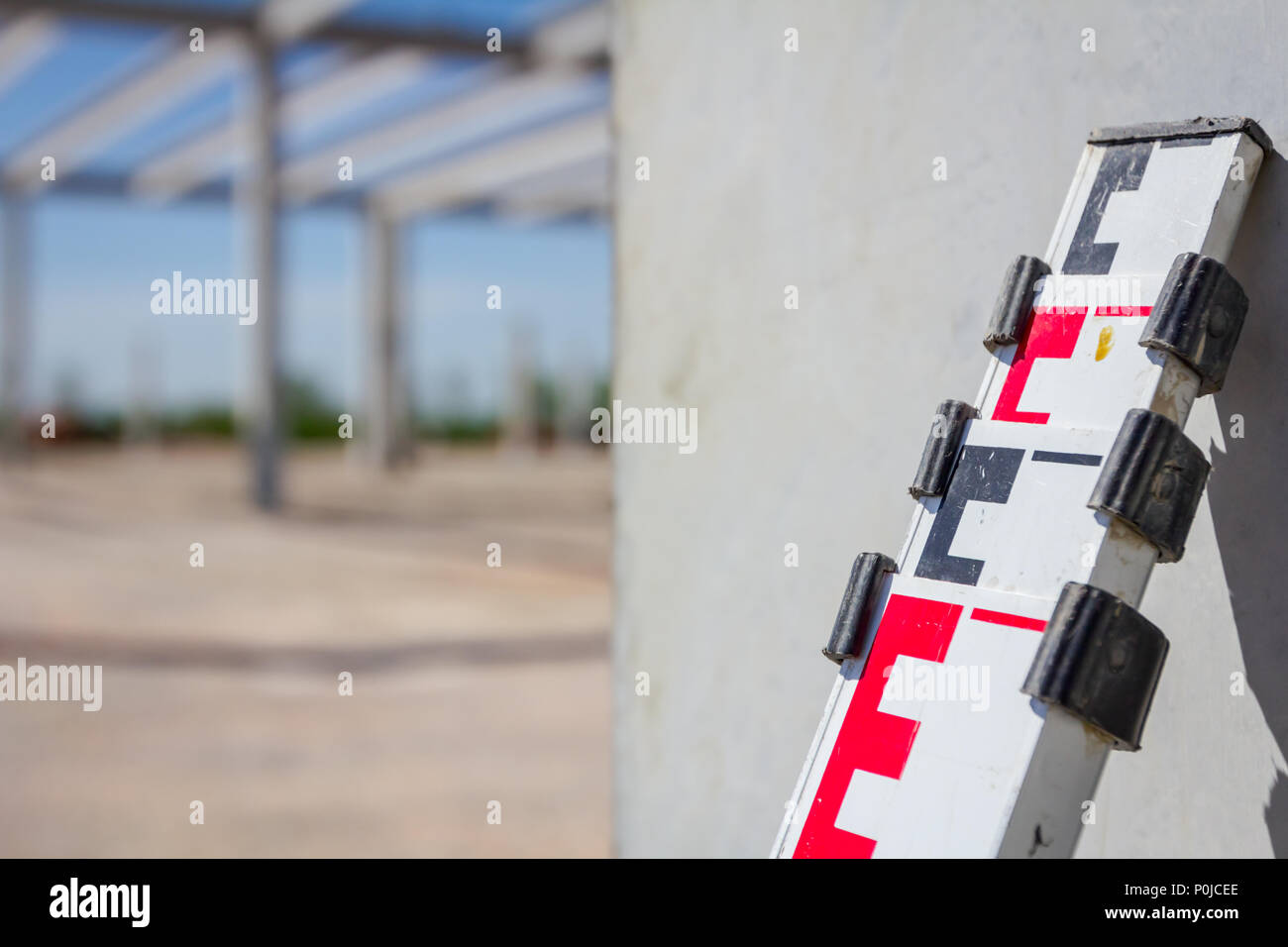 Telescopic leveling lath is helping surveyor, geodesist to measure ...